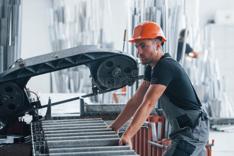 Machine Operator. Man in Uniform Works on the Production Stock Photo ...