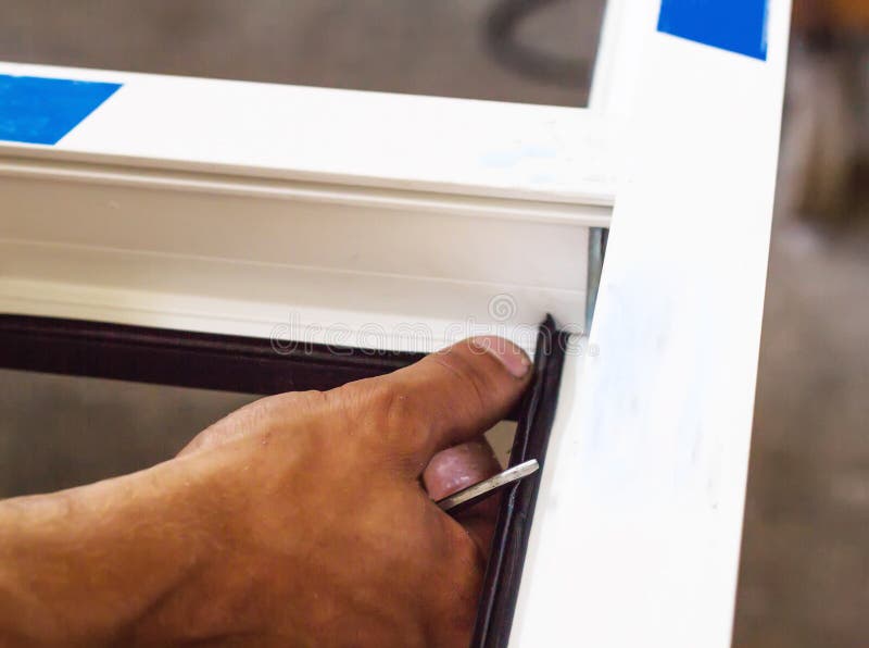 Production of Pvc Windows, the Worker Installs the Sealing Rubber in ...