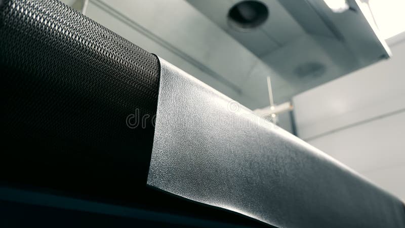Production of a Rubber Mat. a Piece of Rubber that Shines in the Light ...