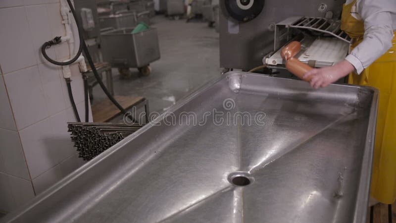 Production of Sausages. Worker Operates Meat Processing Equipment at a ...