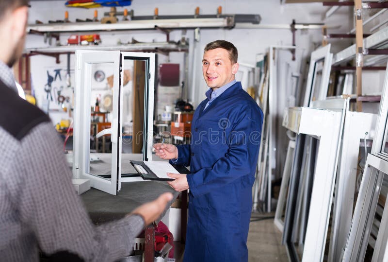 Production Worker in Coverall Demonstrating Different PVC Window Stock ...
