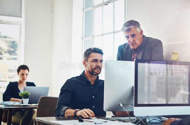 Productive Teamwork in Action. Colleagues Using a Computer Together in ...
