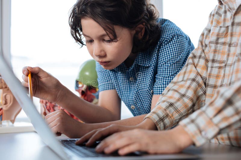 Productive Thoughtful Kids Perusing Some Data Stock Photo - Image of ...