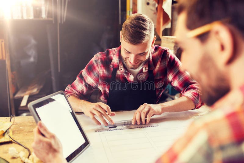 Workmen with Tablet Pc and Blueprint at Workshop Stock Photo - Image of ...