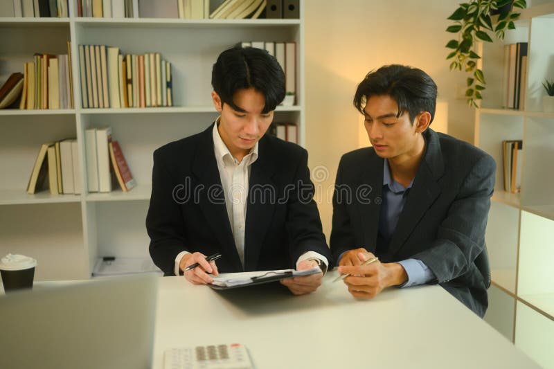 Professional Advisor and Client Reviewing and Discussing Contract Terms ...