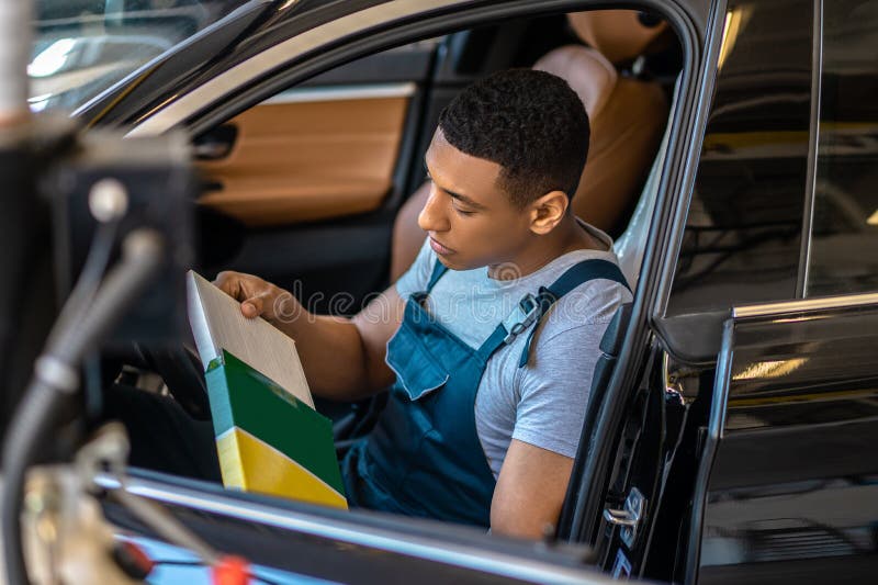 Professional African American Mechanic Fixing the Customer Car Stock ...