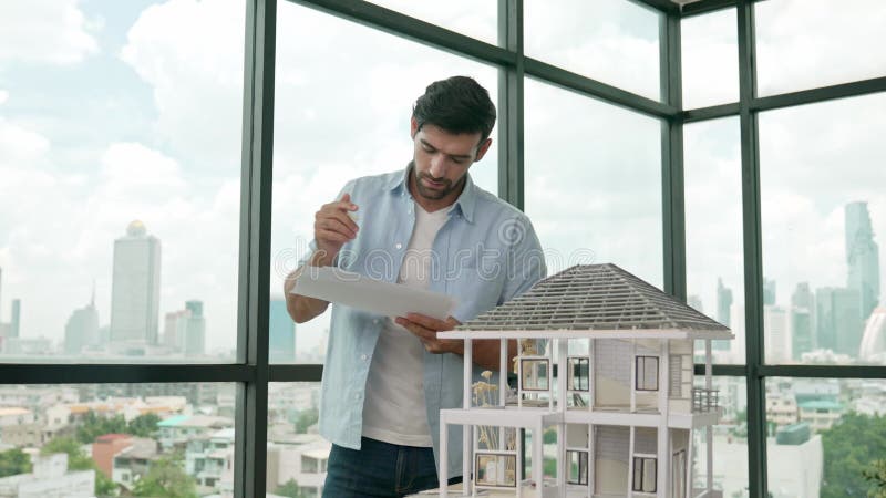 Professional Architect Comparing between Blueprint House Model. Tracery ... Professional Architect Comparing between Blueprint House Model. Tracery ...