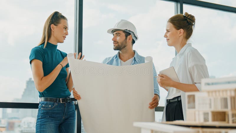 Engineer Team Talk about Design while Manager Hold at Project Plan ...