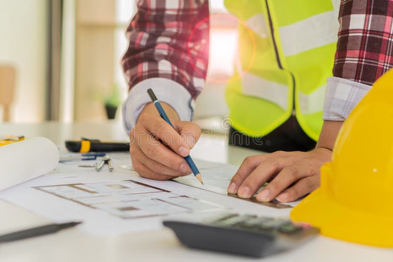 Professional Architect Working on Blueprints and Construction Plans ...