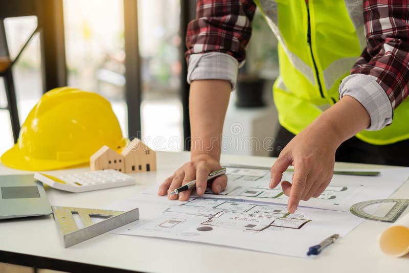 Professional Architect Working on Blueprints and Construction Plans ...