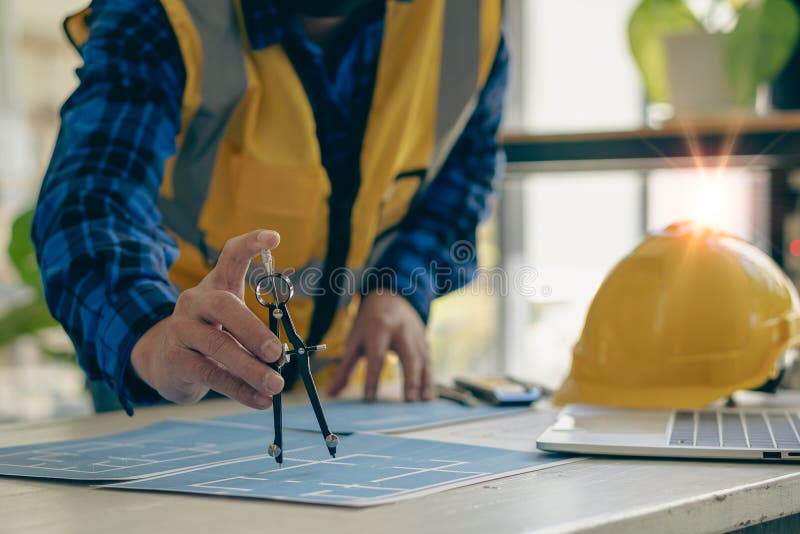 Professional Architect Working on Blueprints and Construction Plans ...