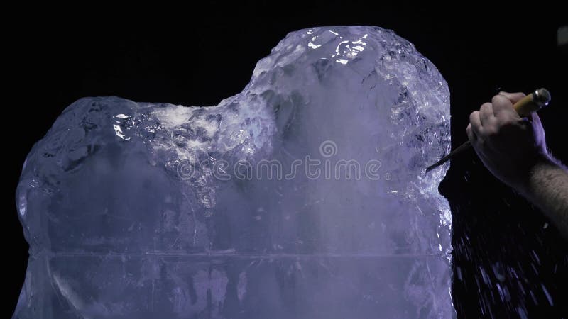 Man Creating an Ice Sculpture in the Studio Using a Chisel and Hammer ...