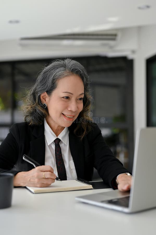 Professional Asian Senior Female Doctor Examining a Patient in Her ...