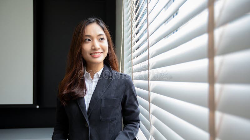 Professional Asian Business Woman Standing Confidently Smiling in the ... Professional Asian Business Woman Standing Confidently Smiling in the ...