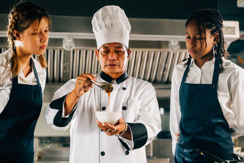 Professional Asian Senior Chef Instructs Diverse Students in a ...