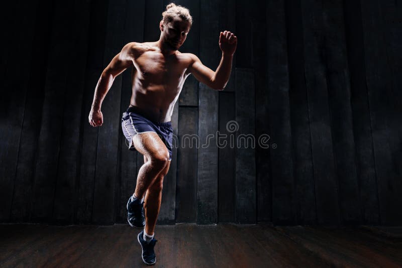 Professional Athlete, Runner Training on Dark Background. Stock Image ...