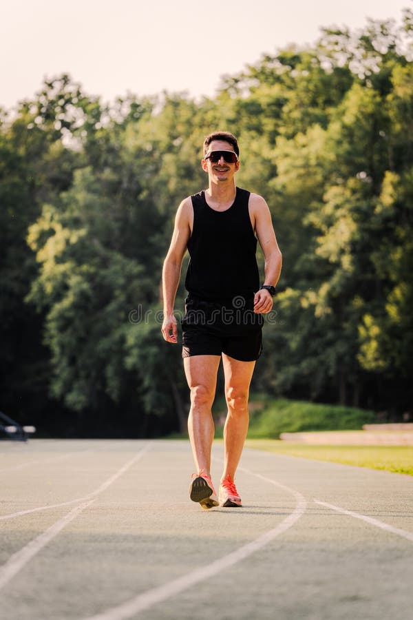 Professional Athlete in Training Clothes Smiling while Walking on the ...