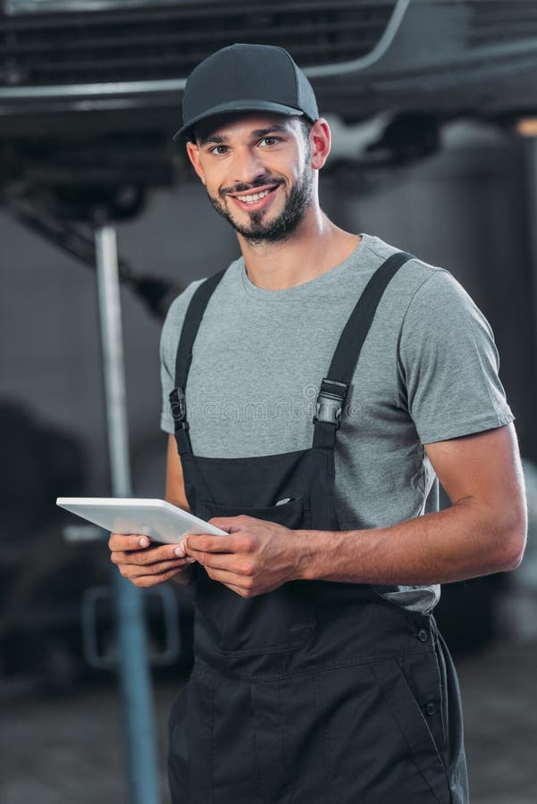 Professional Auto Mechanic in Overalls Using Stock Image - Image of ...
