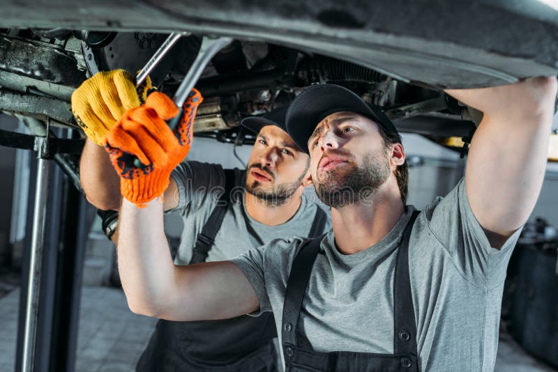 Professional Auto Mechanics Working with Car and Tools Stock Photo ...