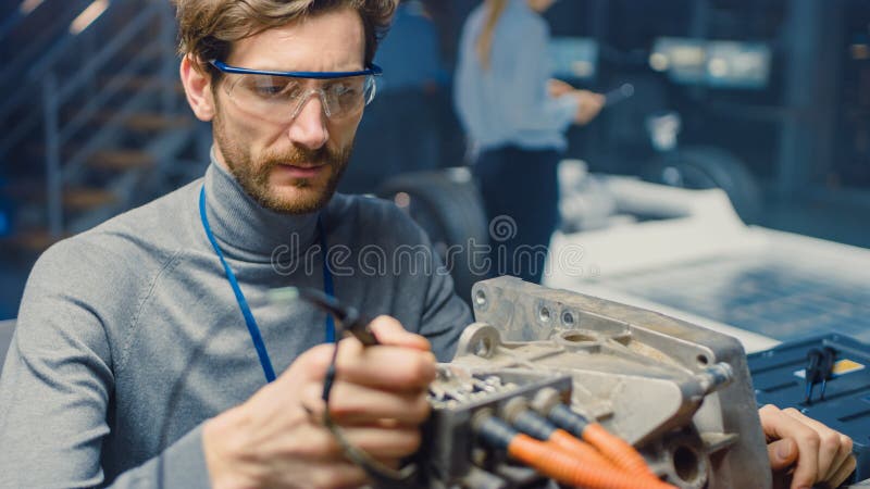 Professional Automotive Engineer in Glasses with a Computer and ...