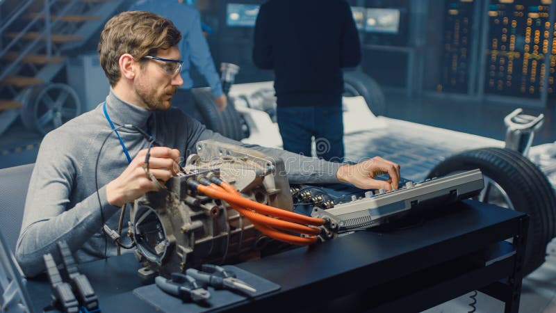 Professional Automotive Engineer in Glasses with a Computer and ...