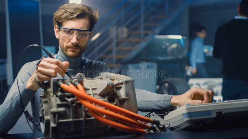 Professional Automotive Engineer in Glasses with a Computer and ...