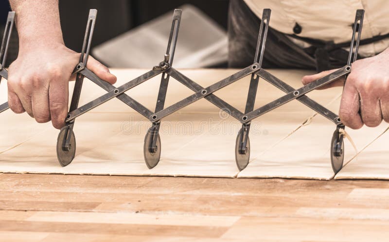 Professional Baker Cuts Dough with Multiple Wheel Pastry Cutter Stock ...