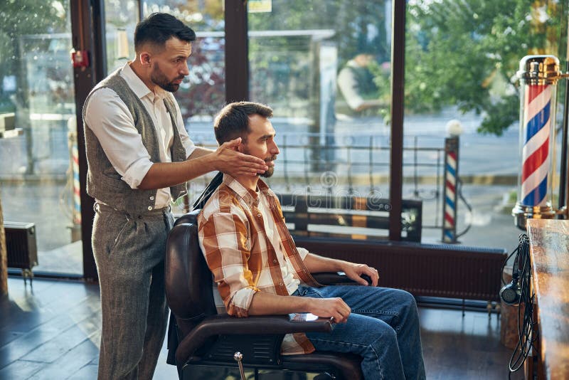 Attentive Barber Leaning To the Client and Talking To Him Stock Image ...