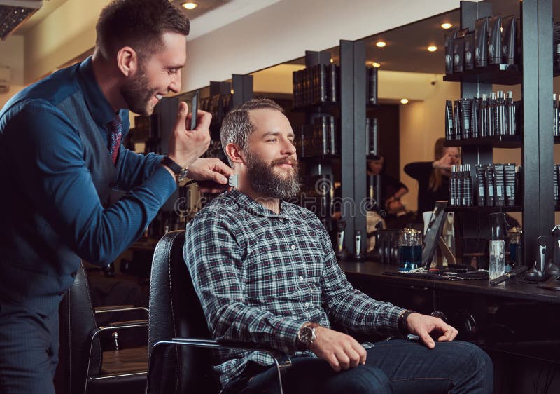 Professional Barber Working with a Client in a Hairdressing Salon ...