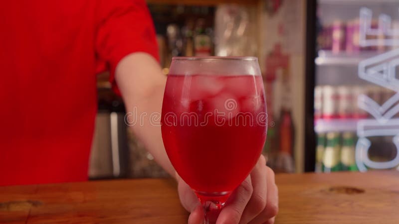 Professional Bartender Preparing a Cocktail with Ice a Mix of Red Syrup ...