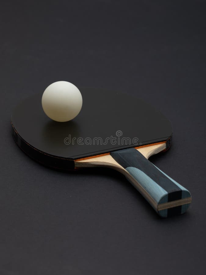 Professional Black Table Tennis Paddle with White Ball in Dramatic ...