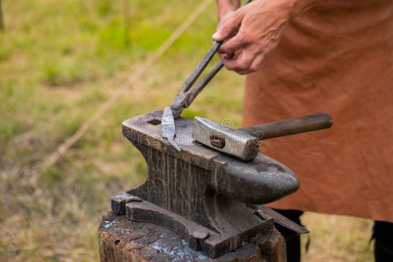 Blacksmith Working with Metal on Anvil at Outdoor Workshop - Close Up ...