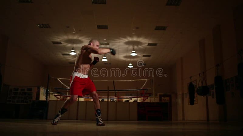 A Professional Boxer in the Background of the Ring Spends Shadow Boxing ...