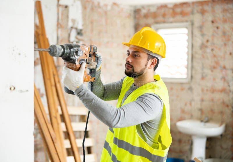Professional Builder Drills a Wall with a Hammer Drill Stock Image ...
