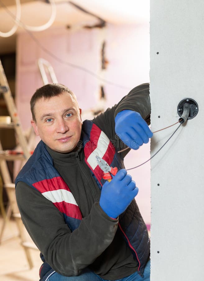 Professional Builder Engaged in Electrical Installation Work at Indoors ...