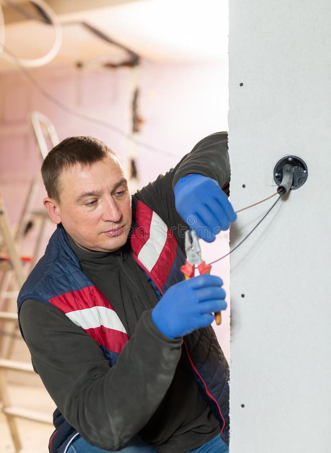 Professional Builder Engaged in Electrical Installation Work at Indoors ...