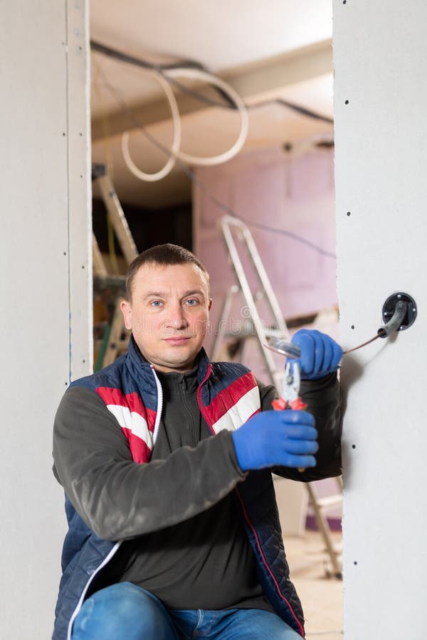 Professional Builder Engaged in Electrical Installation Work at Indoors ...