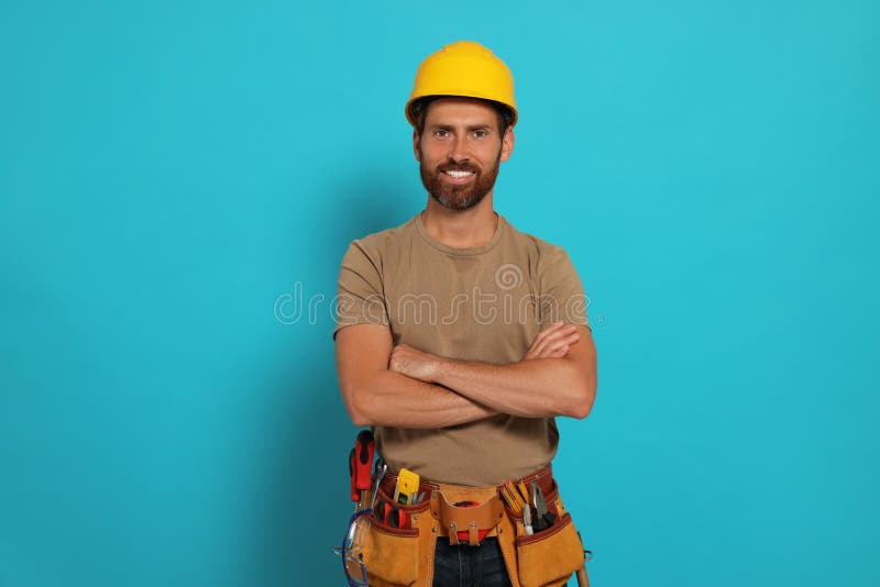 Professional Builder in Hard Hat with Tool Belt on Light Blue ...