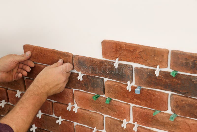 Professional Builder Installing New Brown Decorative Bricks on Wall ...