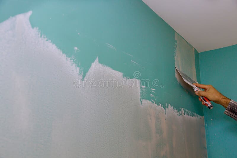 Builder with a Putty Knife, Apply the Putty To the Wall. Repair the ...