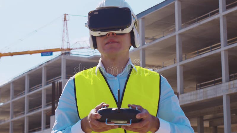 Professional Builder Standing in Front of Construction Site. Foreman in Hardhat Helmet and Vest ...
