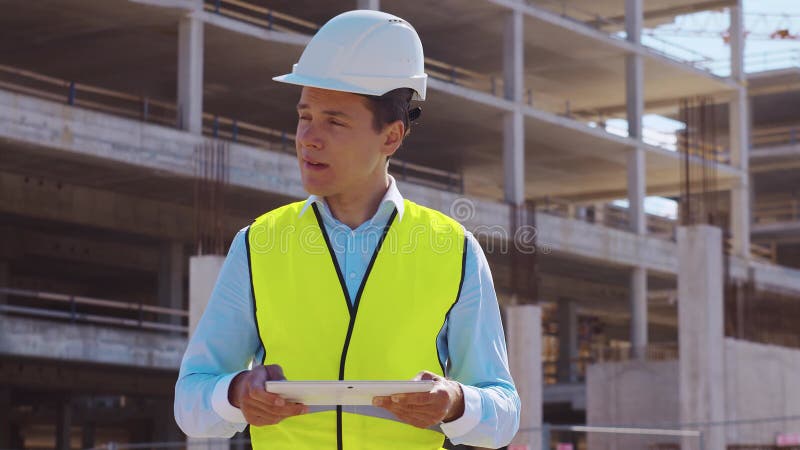 Professional Builder Standing with Tablet Computer in Front of ...