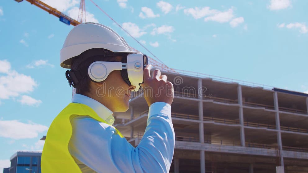 Professional Builder in VR Helmet Standing in Front of Construction ...