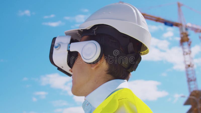 Professional Builder in VR Helmet Standing in Front of Construction ...