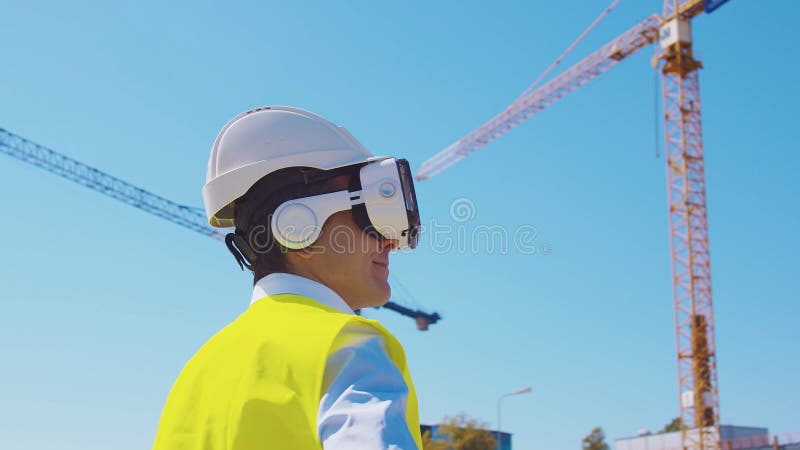 Professional Builder in VR Helmet Standing in Front of Construction ...