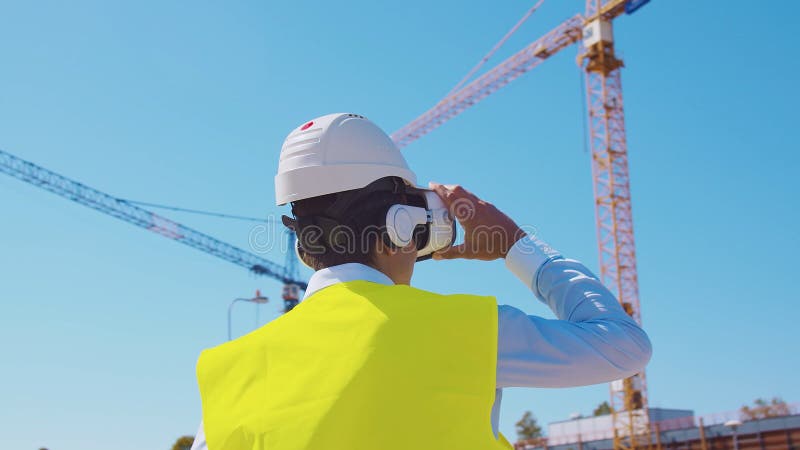 Professional Builder in VR Helmet Standing in Front of Construction ...