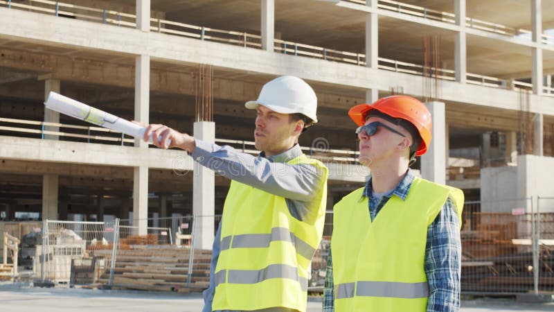 Professional Builders Standing in Front of Construction Site. Office ...