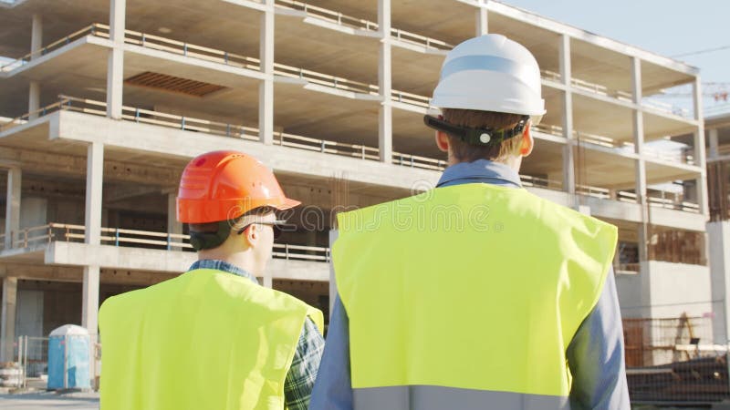 Professional Builders Standing in Front of Construction Site. Office ...