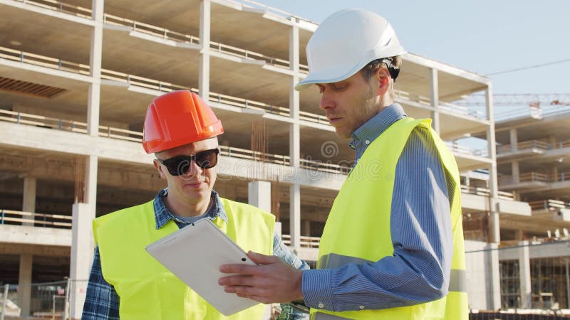 Professional Builders Standing in Front of Construction Site. Office ...