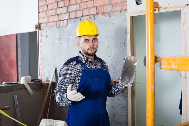 Professional Builer in the Helmet Ready is Plastering the Wall Stock ...